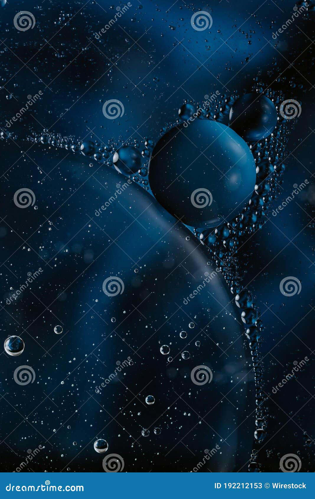Vertical Closeup Shot of Air Bubbles in Water in Front of a Blue ...