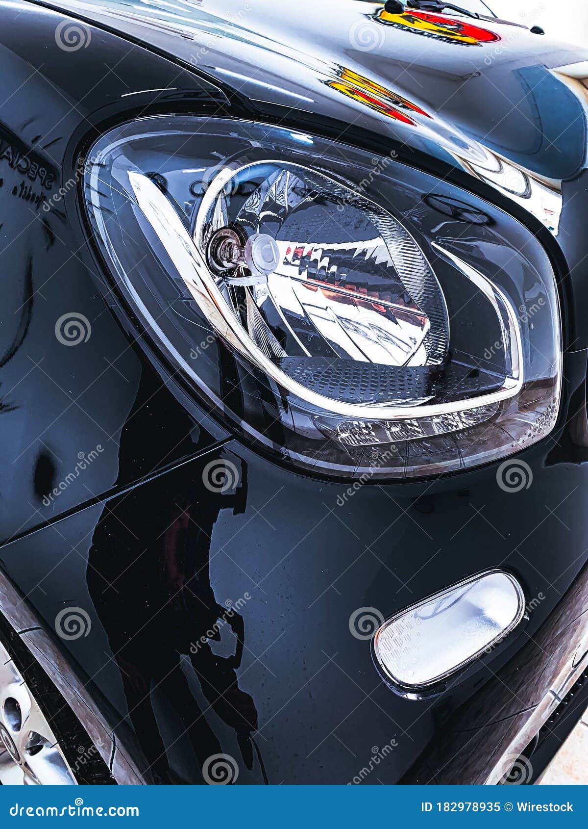 Vertical Closeup Shot of the Headlight of a Modern Black Car Stock ...