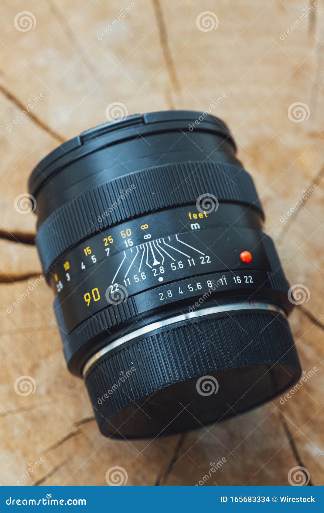 Vertical Closeup Shot of a Professional Camera Lens on a Wooden Surface ...