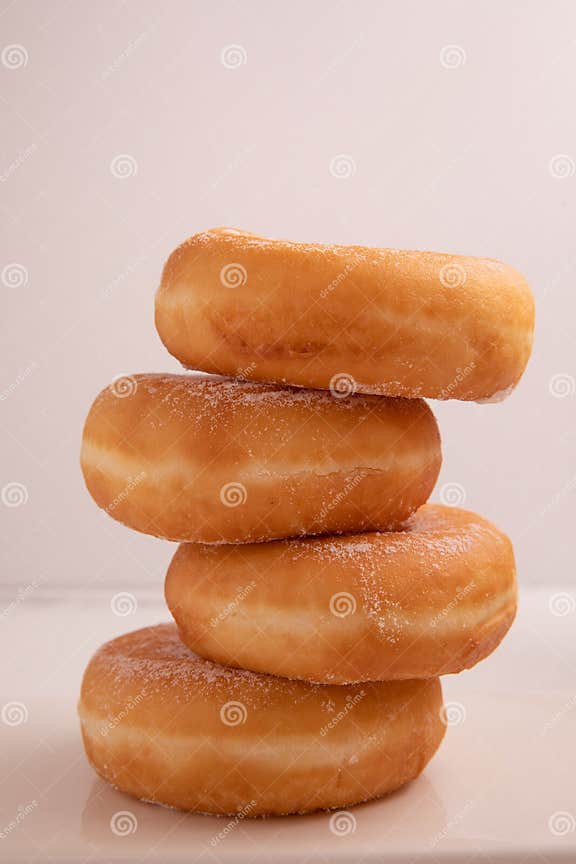 Vertical Closeup of a Stack of Donuts Served on a White Background ...