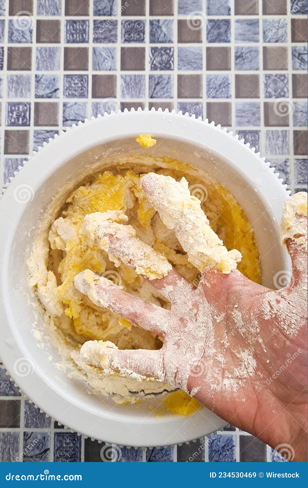 Vertical Closeup Top View of a Human Hand Covered with Dough during the ...