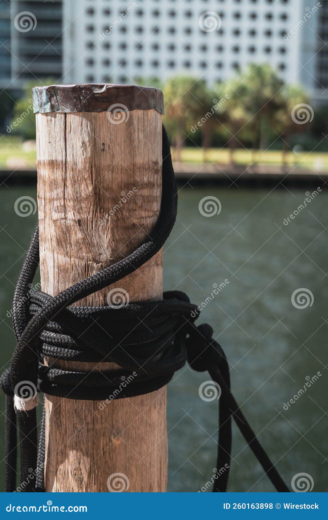 Vertical Closeup of a Wooden Post Wrapped with a Rope on a Pier Stock ...
