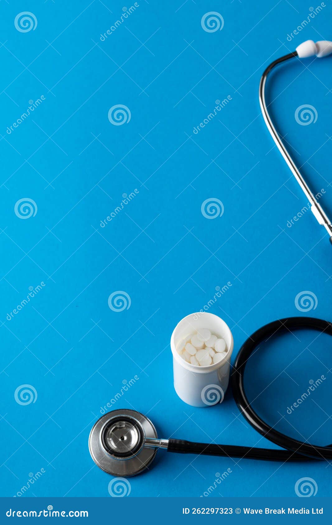 Vertical Composition of Stethoscope with Bottle of Pills on Blue ...