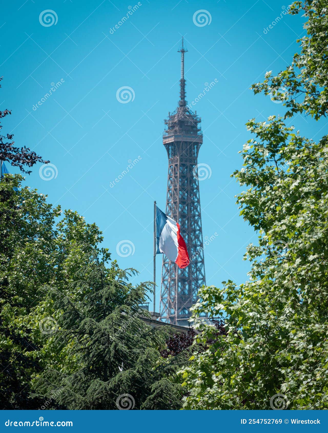 Vertical of the Eiffel Tower S Top Part and the French Flag in Front of ...