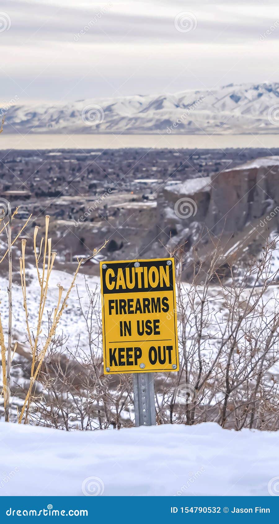Vertical Frame Caution Firearms in Use Keep Out Sign on a Mountain ...