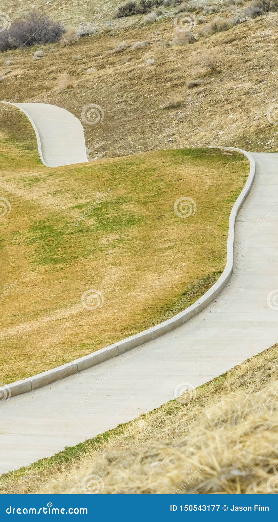 Vertical Frame Close Up of a Paved Pathway Running through the Slope of ...