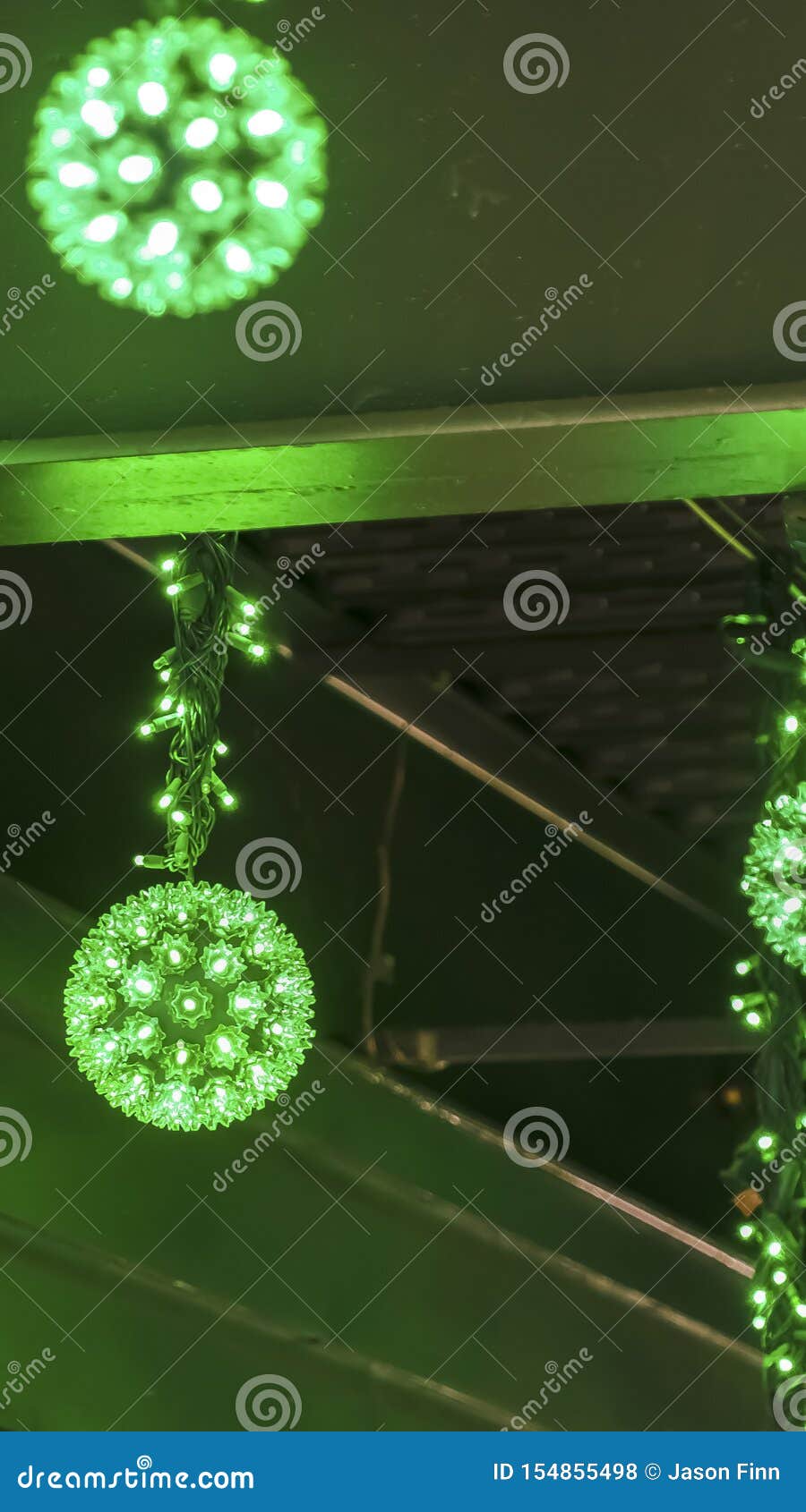 Vertical Frame Close Up View of Several Glowing Neon Green Light Balls ...