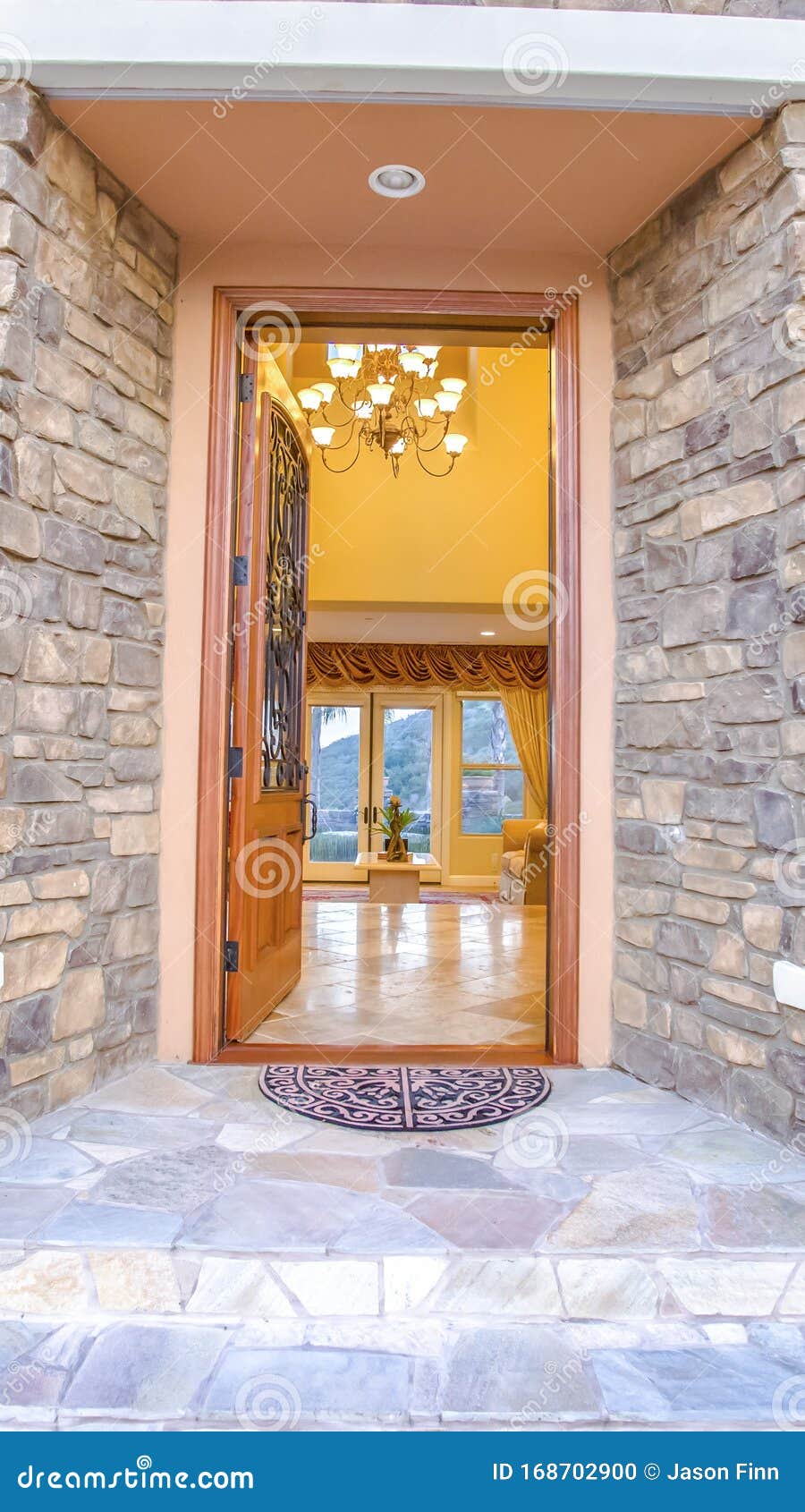 Vertical Frame Wide Open Front Door Looking at Chandlier Stock Photo ...