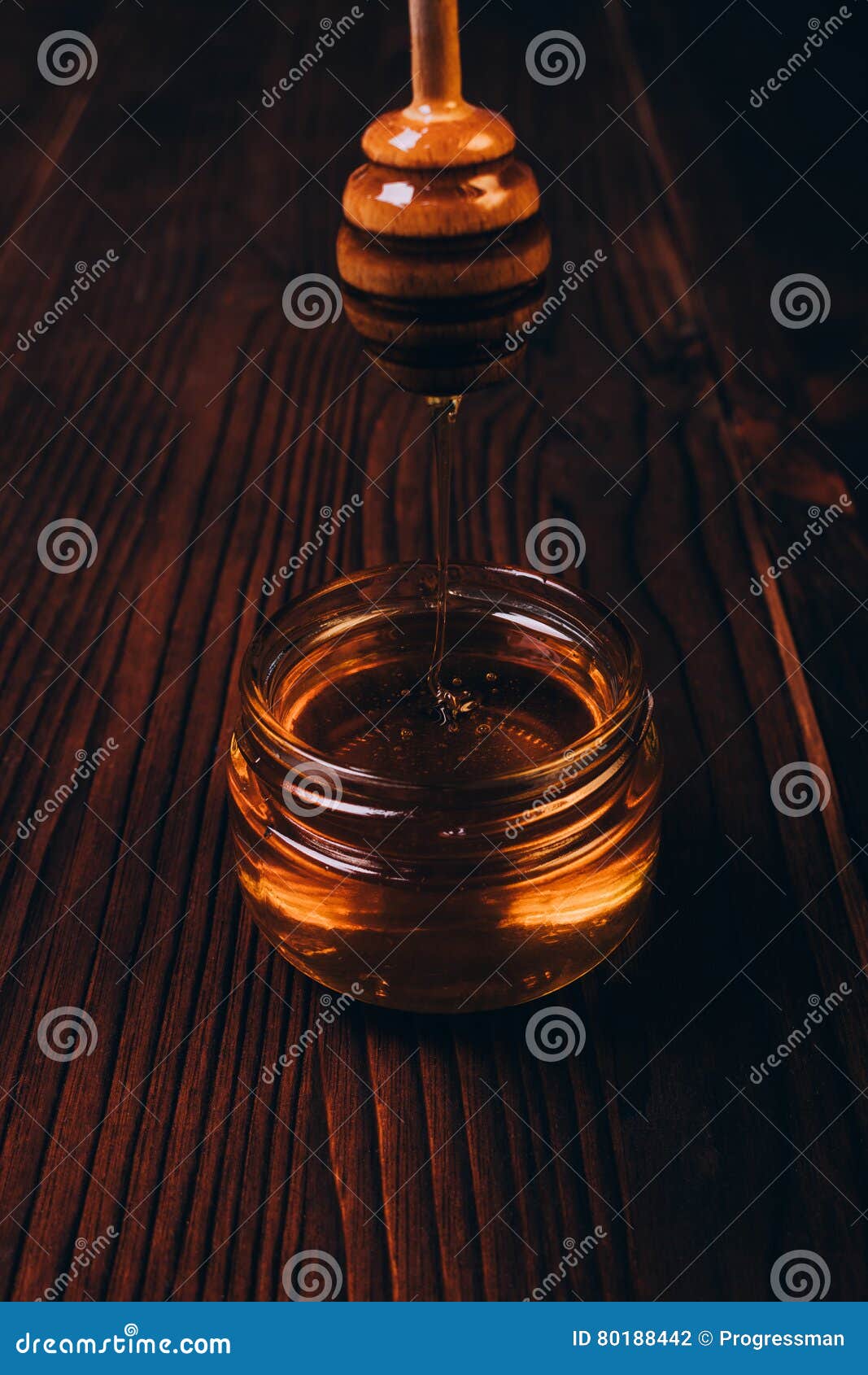 Vertical Frame Honey Dripping into Jar on a Table Stock Photo - Image ...