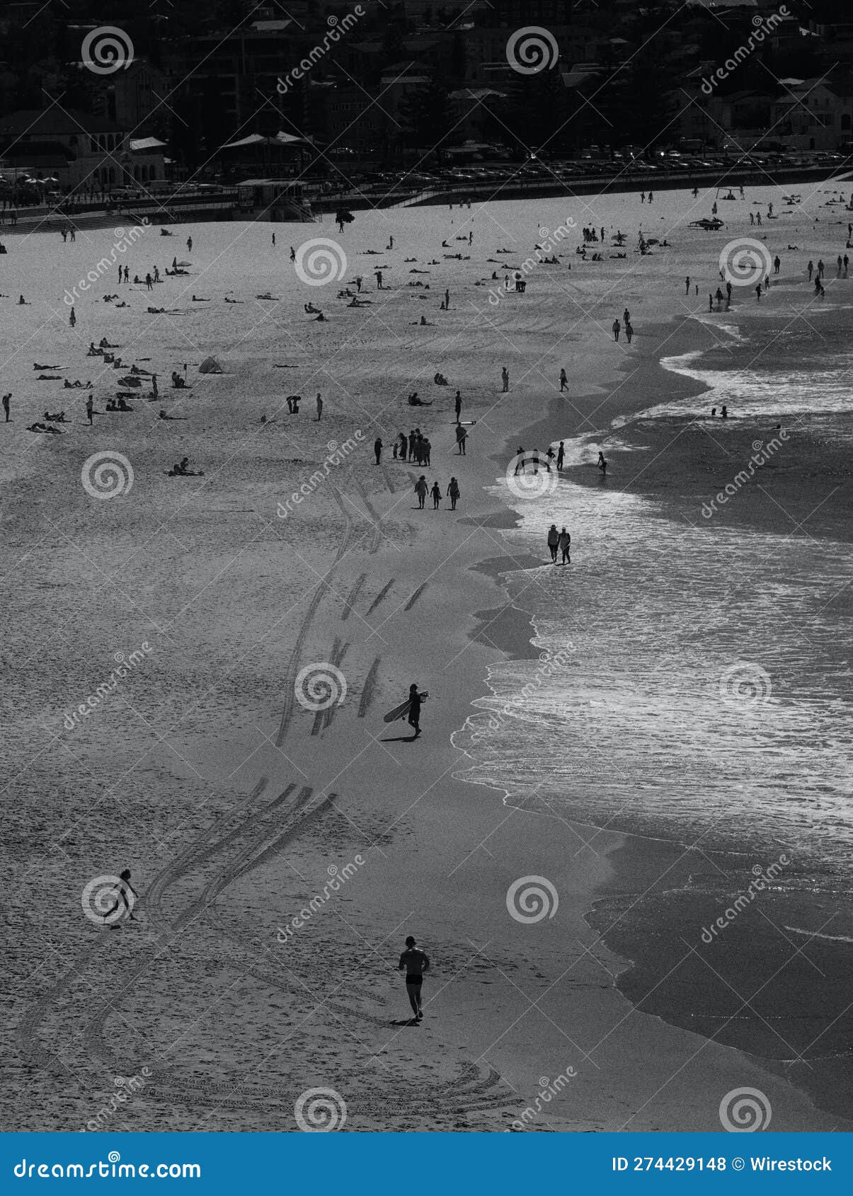 Vertical Grayscale Shot of a Beach Populated by People Walking Around ...