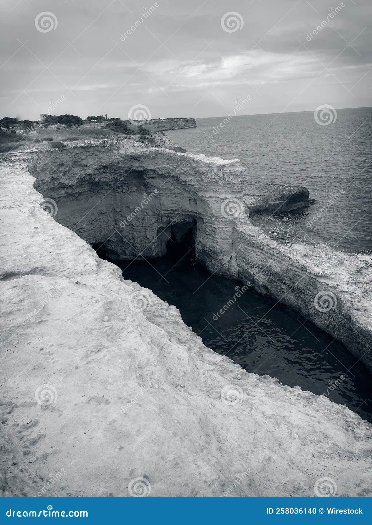 Vertical Grayscale Shot of Cliffs by the Sea Stock Photo - Image of ...
