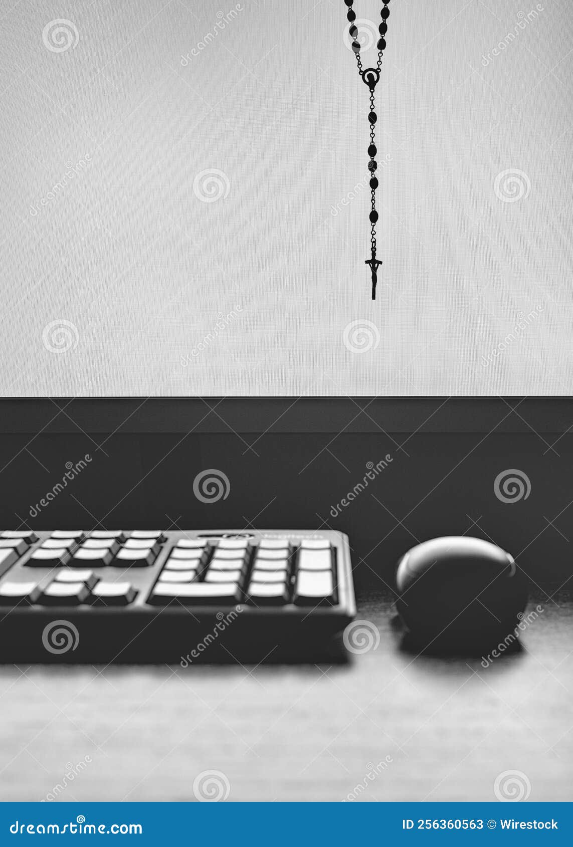 Vertical Grayscale Shot of a Cross Hanging Against the Screen with a ...