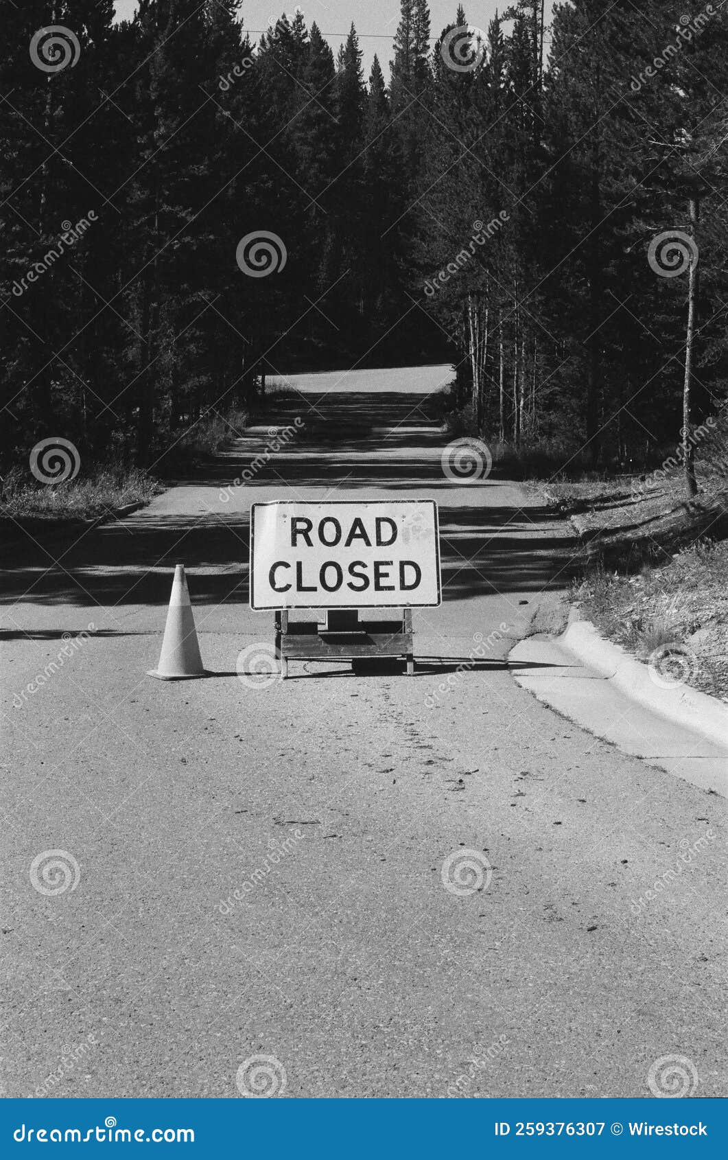 Vertical Grayscale Shot of a Road Closed Sign on the Road Stock Image ...