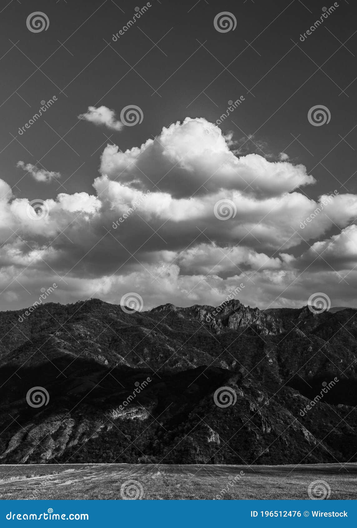 Vertical Grayscale Shot of Rocky Cliffs Under a Cloudy Sky in Armenia ...