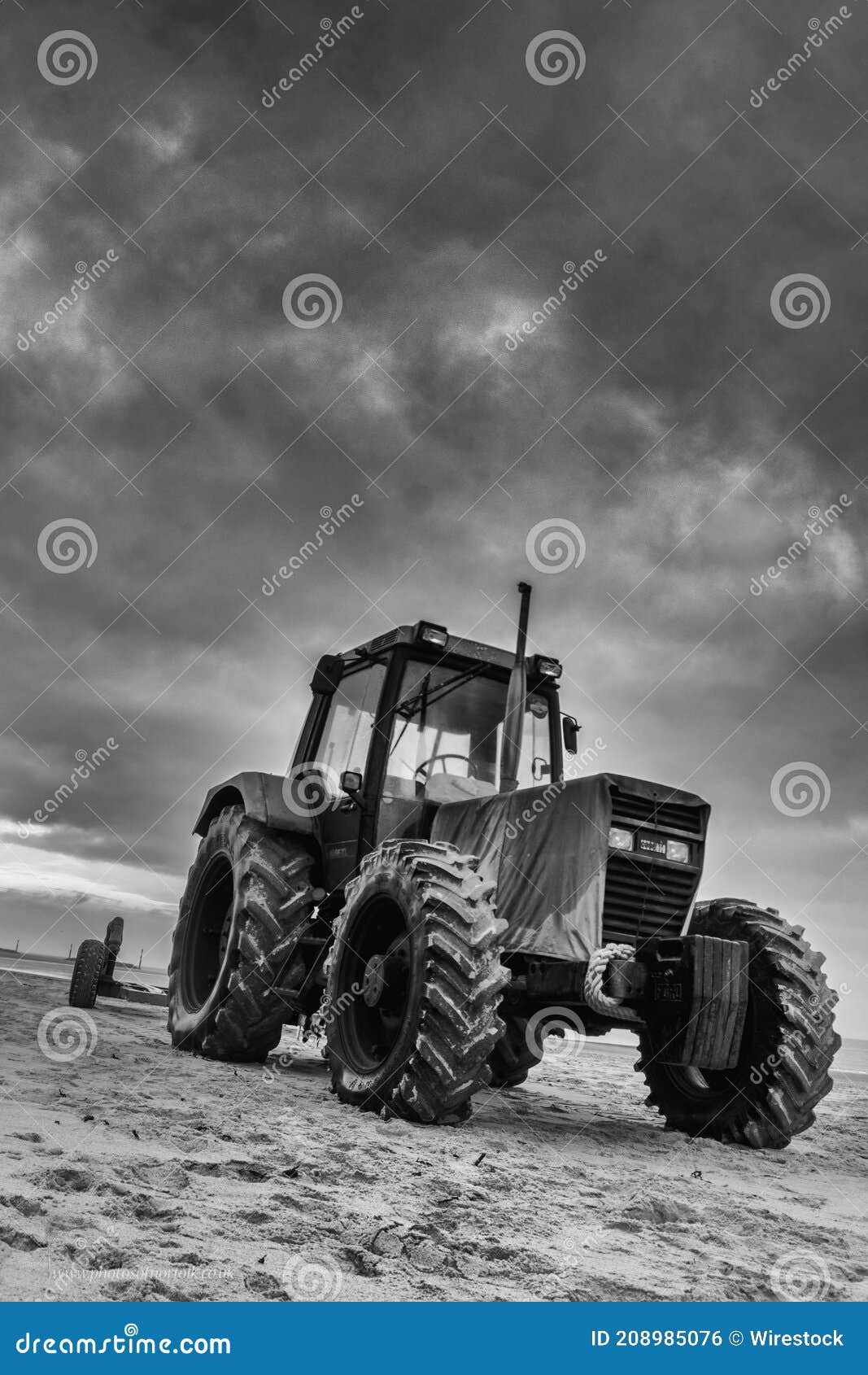 Vertical Grayscale Shot of a Tractor and a Cloudy Dark Sky Stock Photo ...