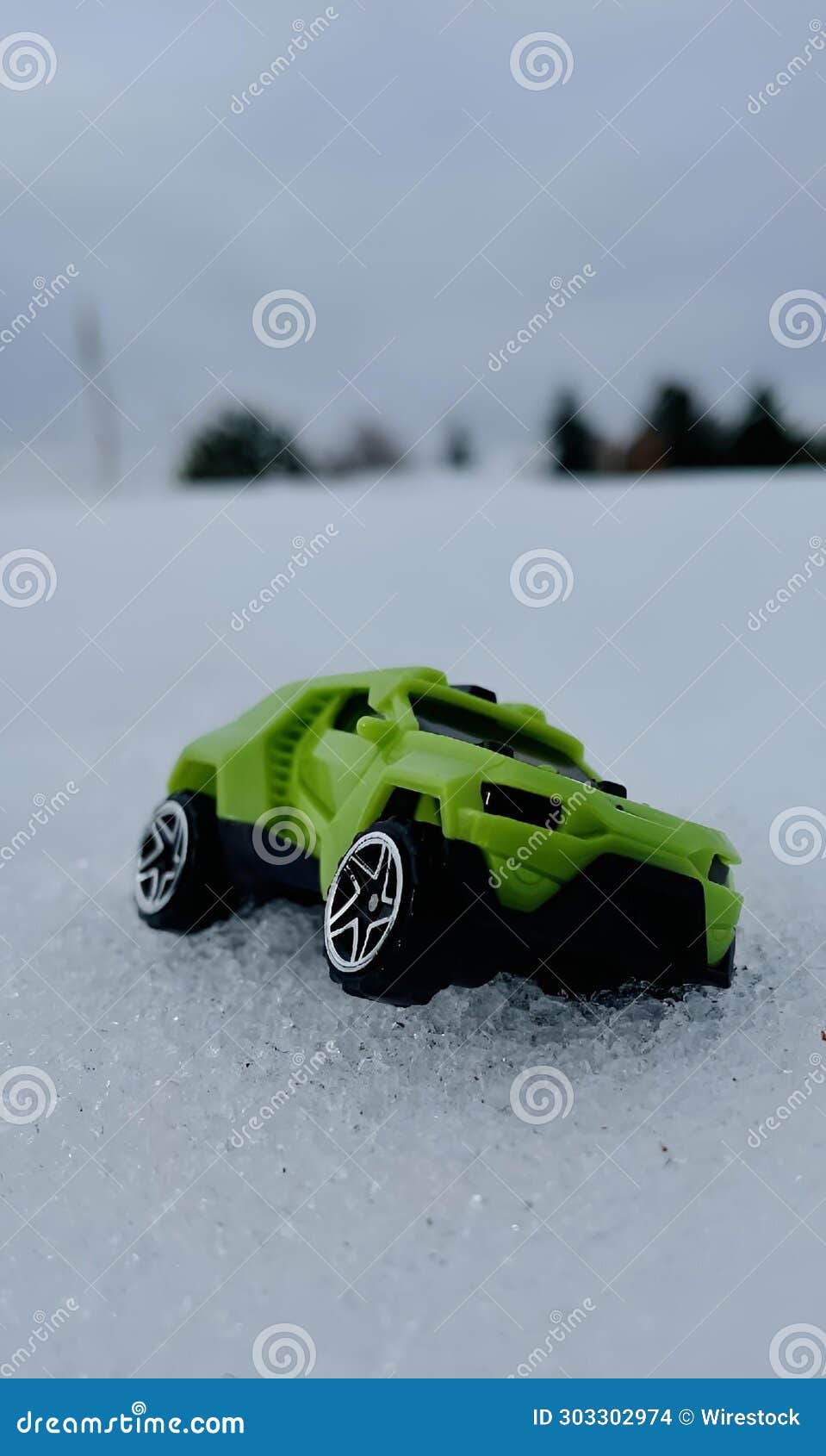 Vertical of a Green Car Toy in the Snow Stock Photo - Image of ...