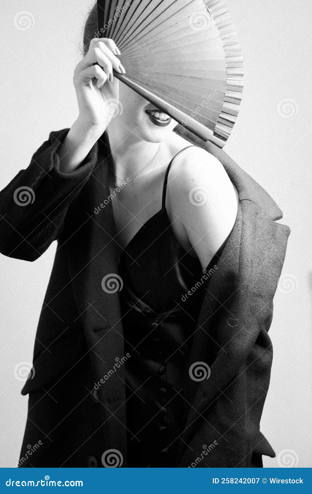 Vertical Greyscale Shot of an Attractive Female Posing with a Fan Stock ...