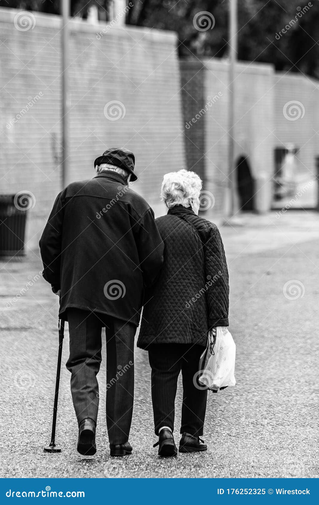 Vertical Greyscale Shot of an Old Romantic Couple Walking Holding Hands ...