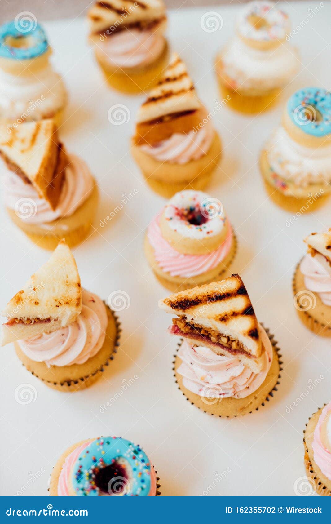 Vertical High Angle Shot of Different Kinds of Cupcakes on White ...