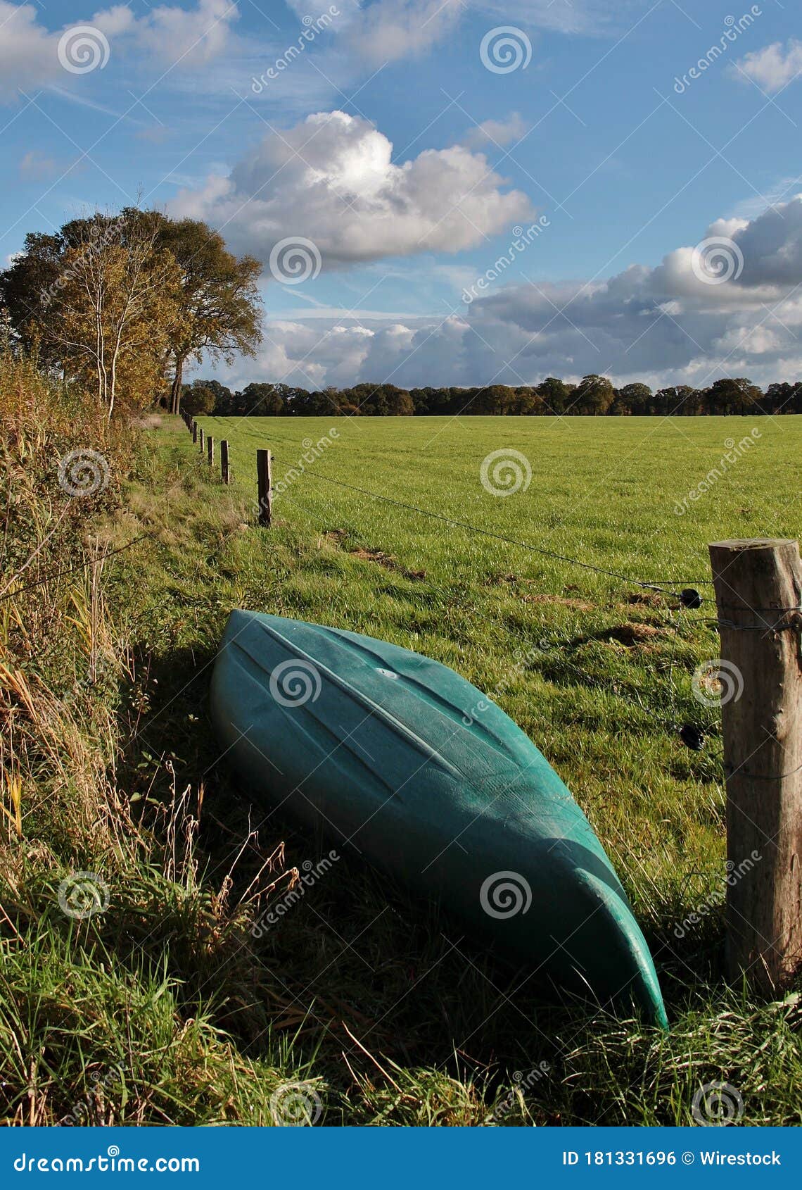 Vertical High Angle Shot of a Green Boat Turned Upside Down in a Green ...