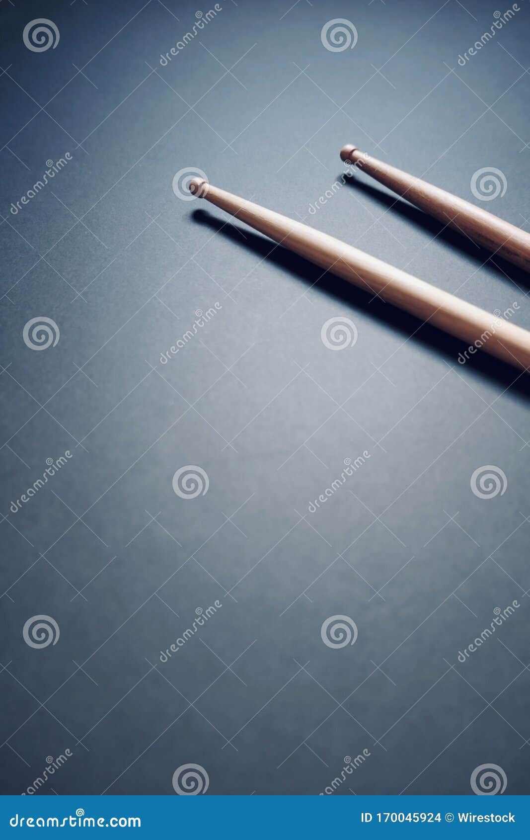 Vertical High Angle Shot of Two Drumsticks on a Blue Surface Stock ...