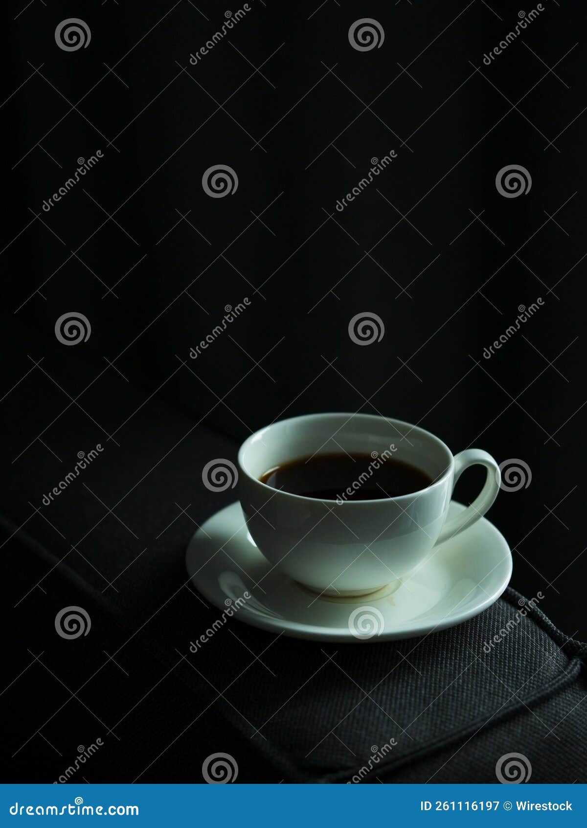 Vertical High Angle Shot of a White Instant Coffee Mug on a Black Couch ...