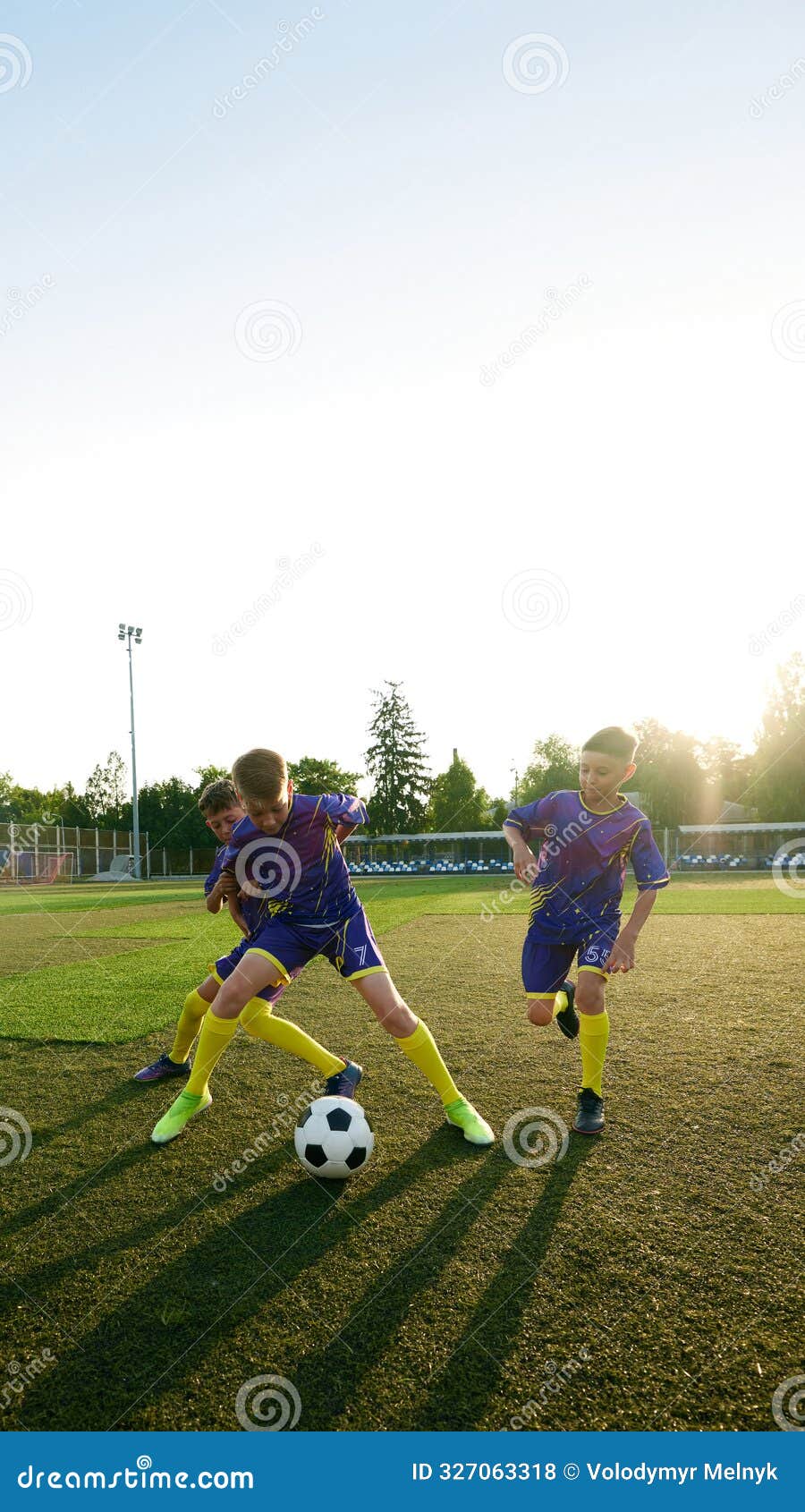 Vertical Image of Boys, Children in Uniform Engaged in Dynamic Soccer ...