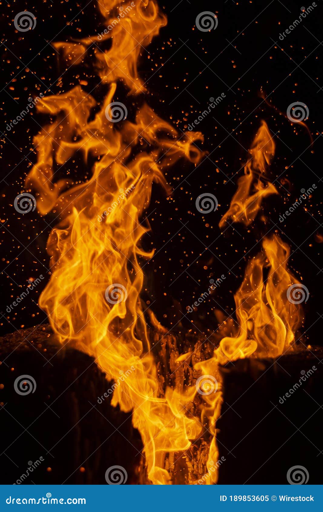 Vertical Image of a Burning Log with Flying Sparks Creating a Fiery ...