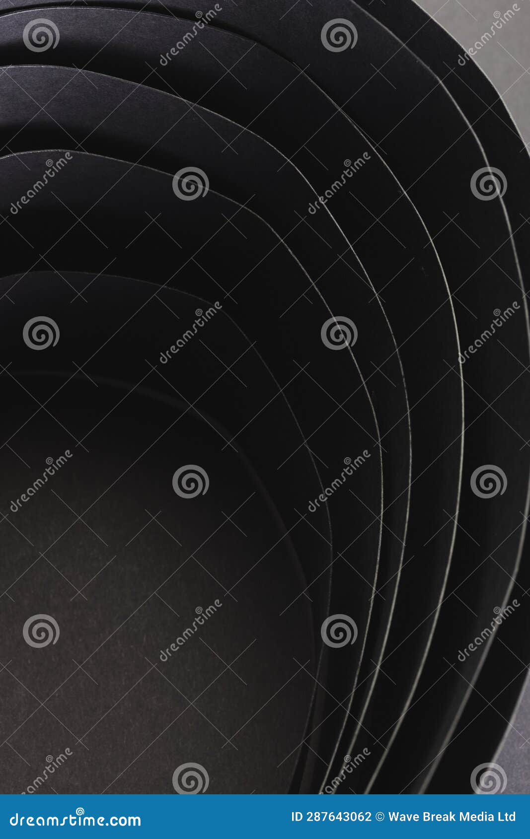 Vertical Image of Close Up of Rolled Up Pieces of Black Paper with Copy ...