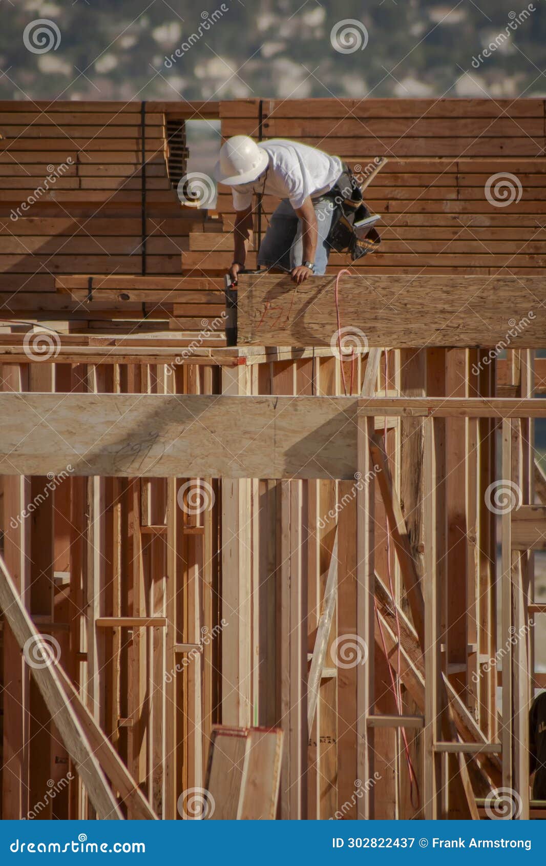 Vertical Image of a Construction Worker on Wood Framing with White Hard ...