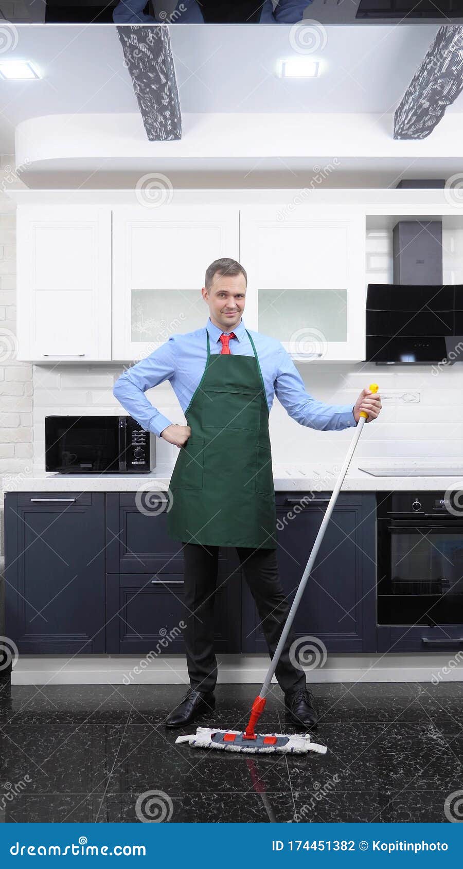 Vertical Image. Handsome Man in Tie and Apron Mops the Floor in the ...