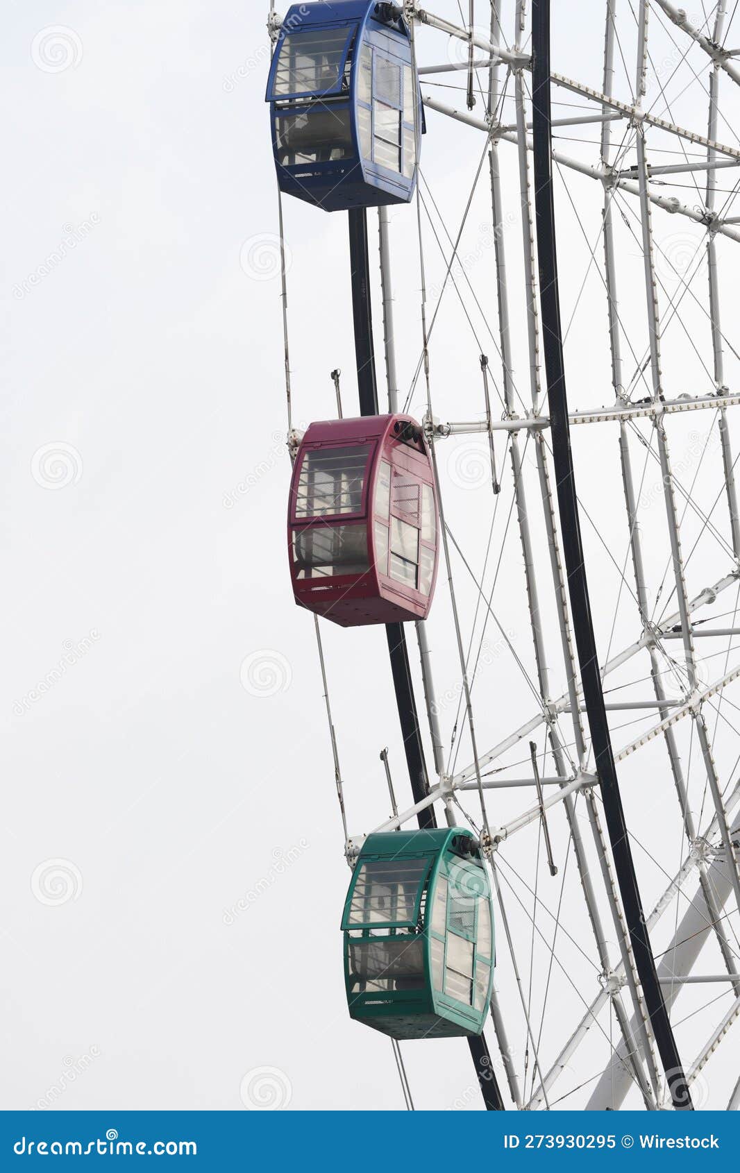 Vertical Image of a Large Ferris Wheel with Colorful Chairs, Against a ...