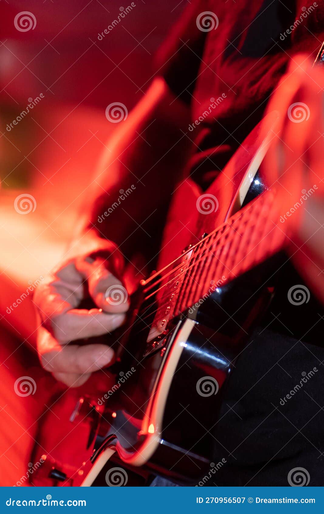 Vertical Image Of A Man Playing The Electric Guitar Shallow Depth Of
