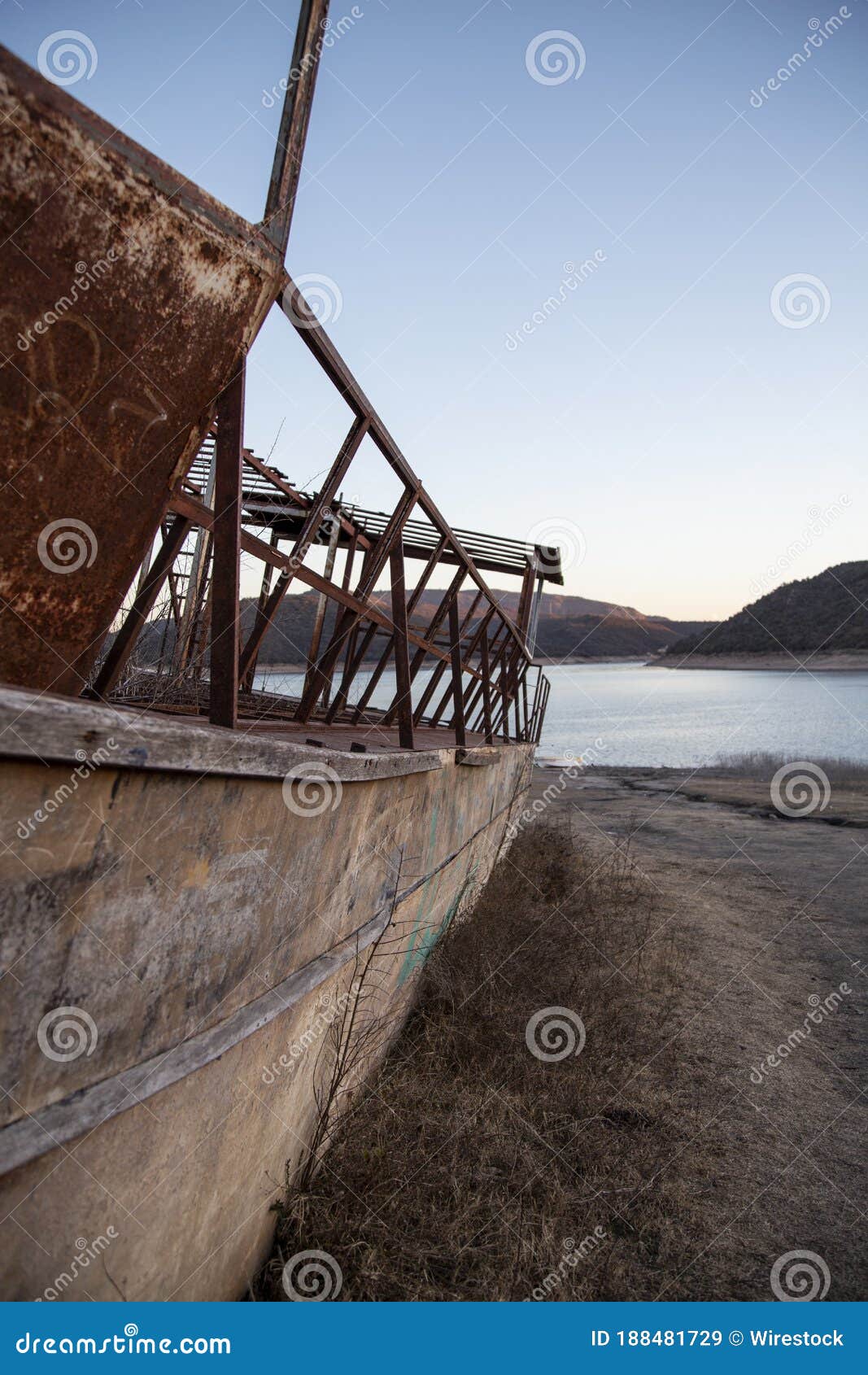 Vertical Image of an Old Rusty Wrecked Boat at the Edge of a Lake Stock ...