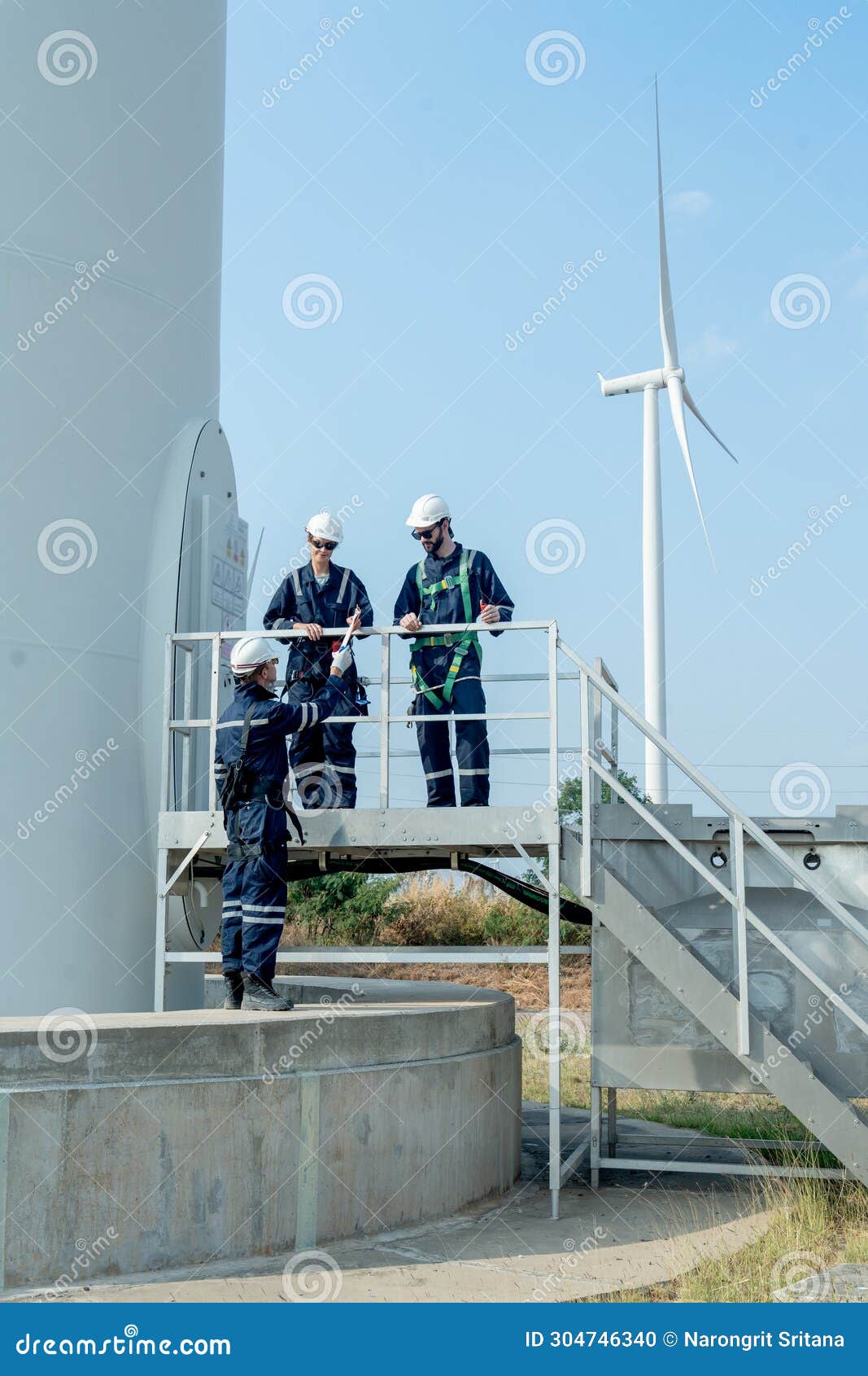 Vertical Image One Technican Worker Give the Document To His Coworker Stand in Base of Windmill ...