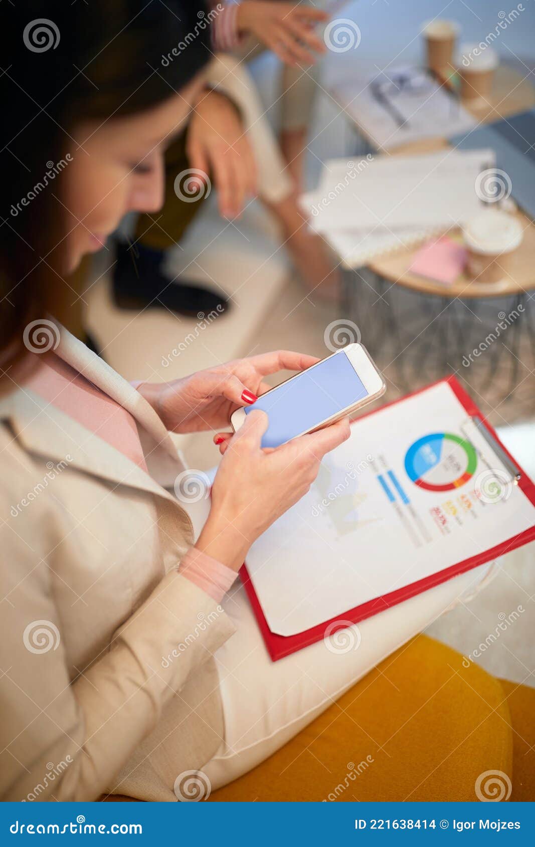 Vertical Image Over the Shoulder of Young Brunette Holding and Looking ...
