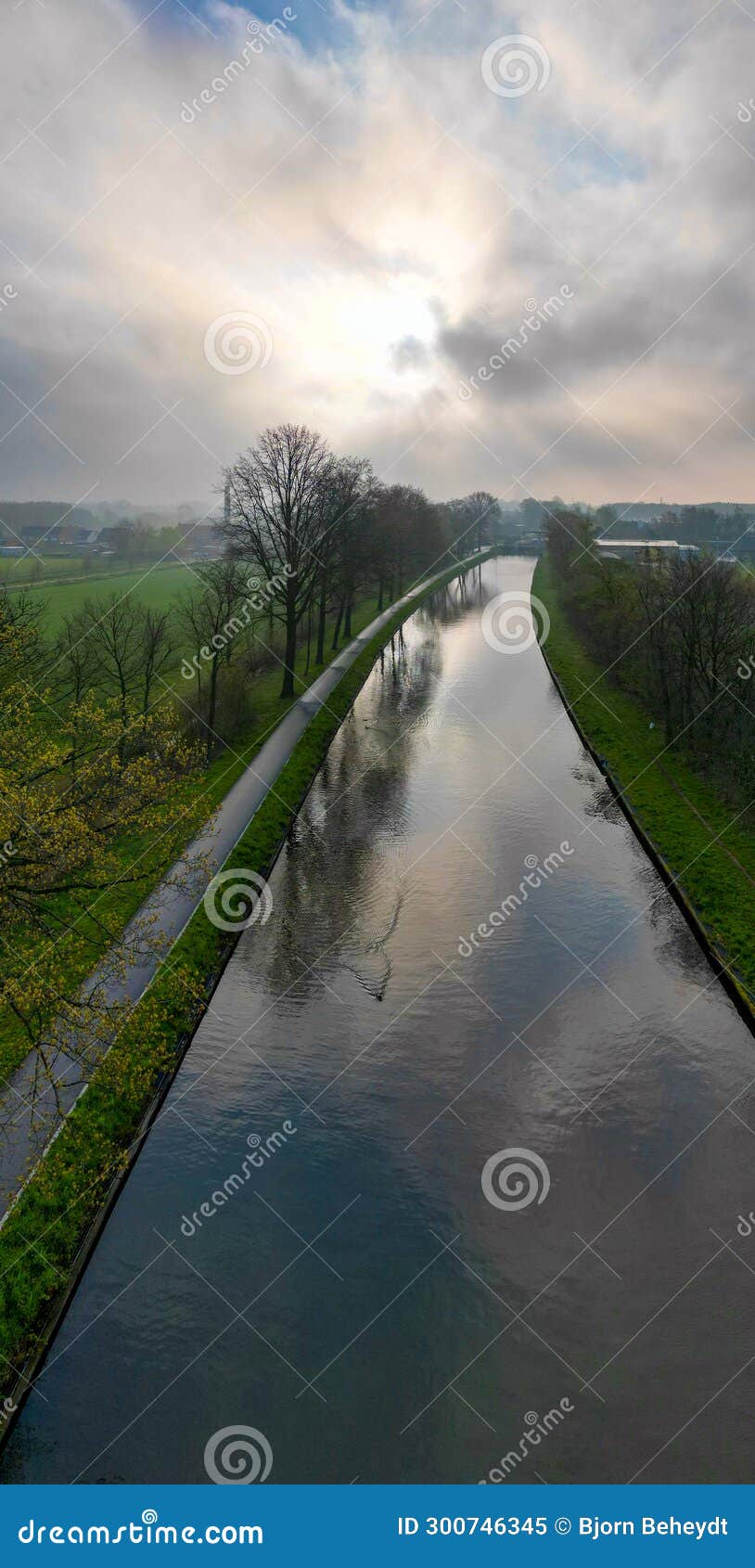 Serene Canal at Sunrise stock image. Image of grass - 300746345