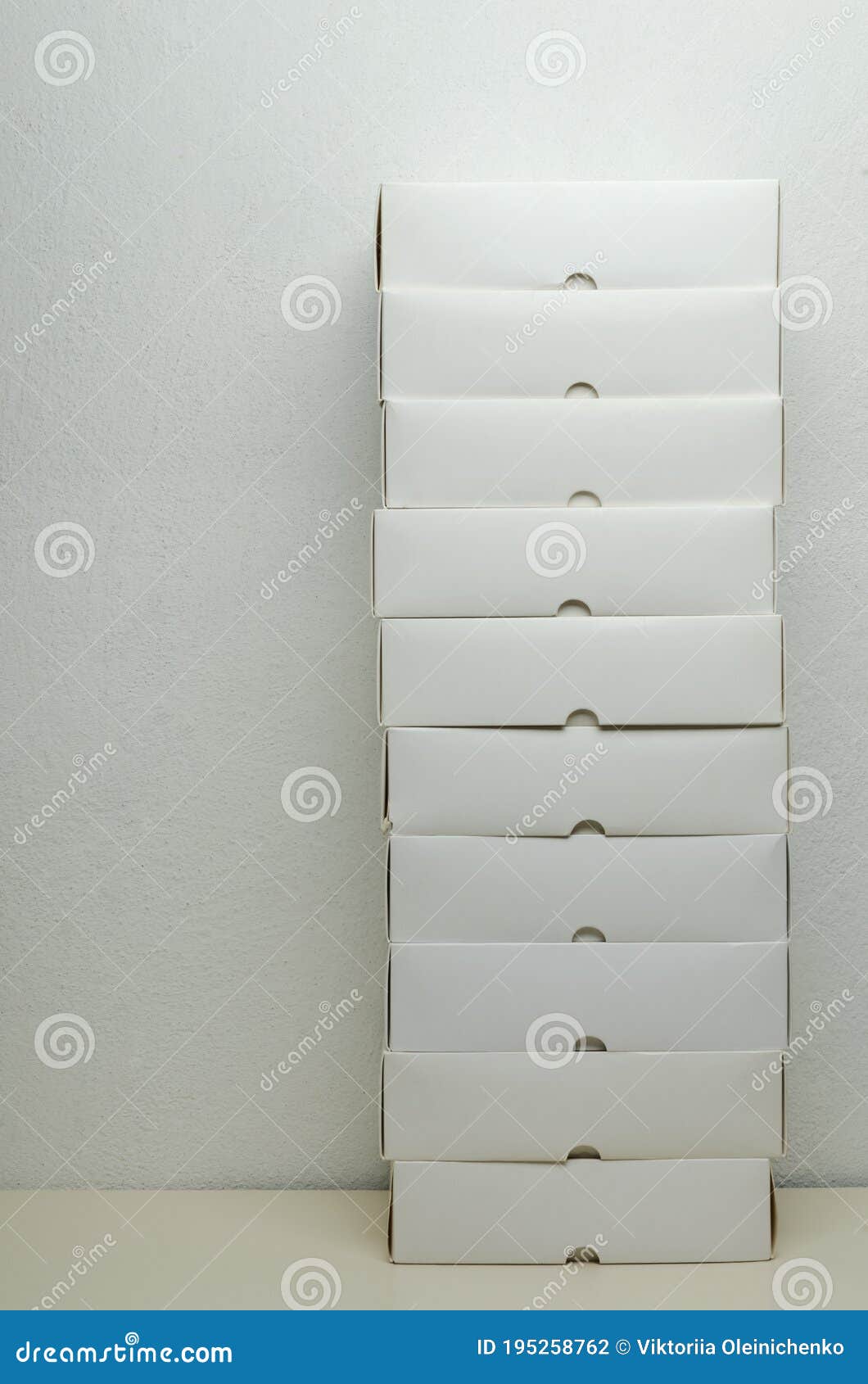 Vertical Image.Stack of White Paper Boxes Against Wall Stock Photo ...
