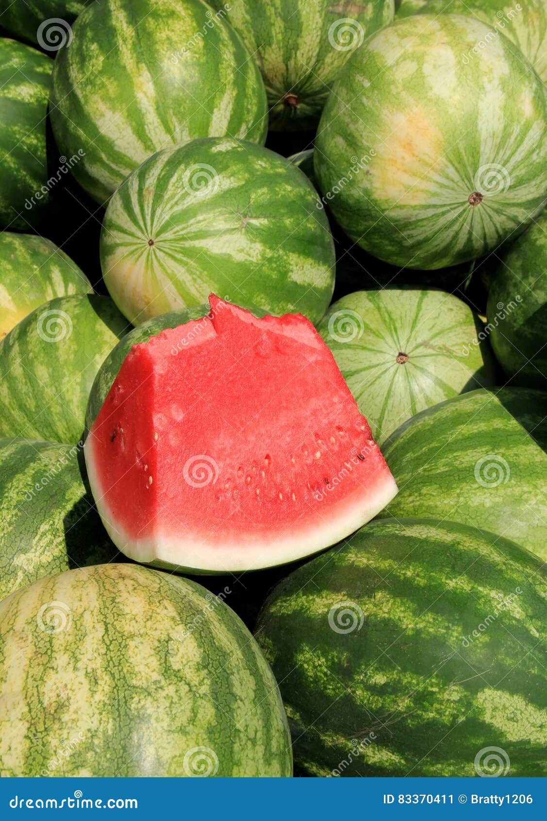 Vertical Image of Large Watermelons, One Sliced Open To Show Freshness ...