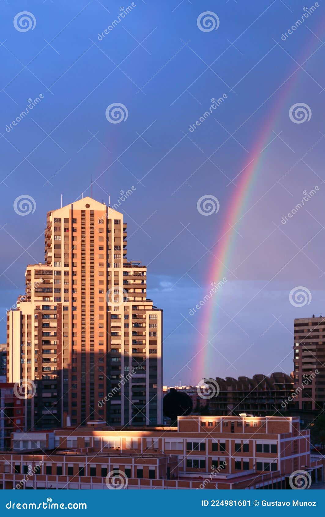 Vertical Image of a Tall Building in Valencia with a Rainbow Next To it ...