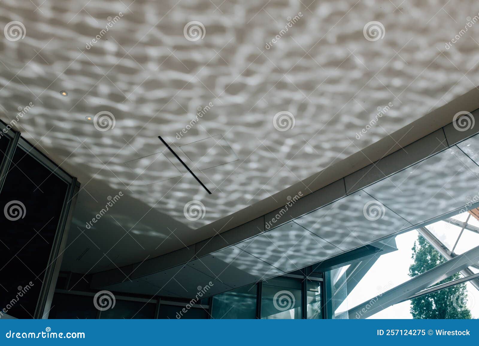 Vertical of an Interior of Modern Beige Building with a Windows Ceiling ...