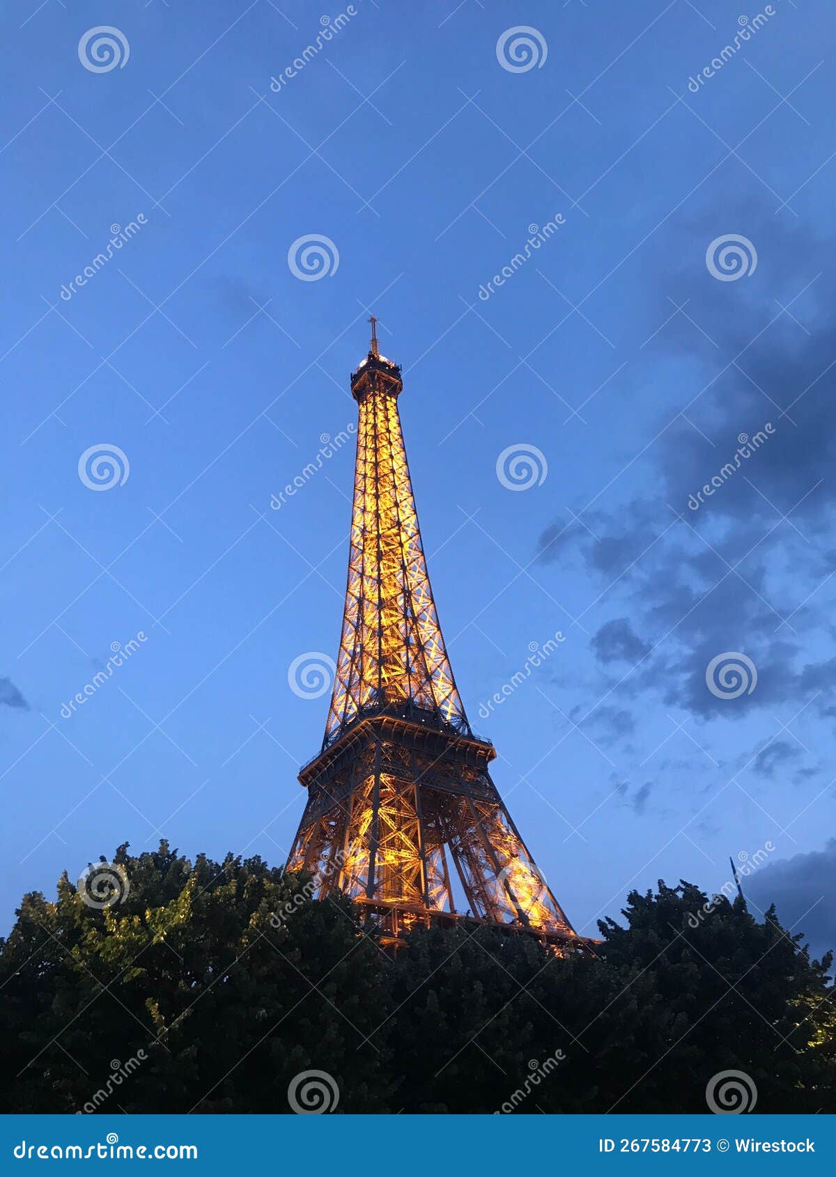 Vertical Low Angle of the Eiffel Tower with Yellow Lighting in the ... Vertical Low Angle of the Eiffel Tower with Yellow Lighting in the ...