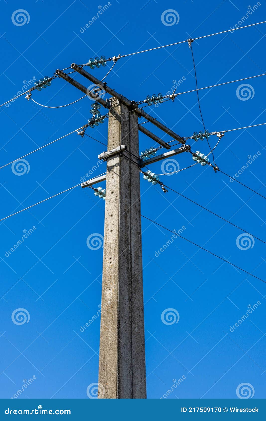 Vertical Low Angle of an Electric Post Isolated on Blue Background ...