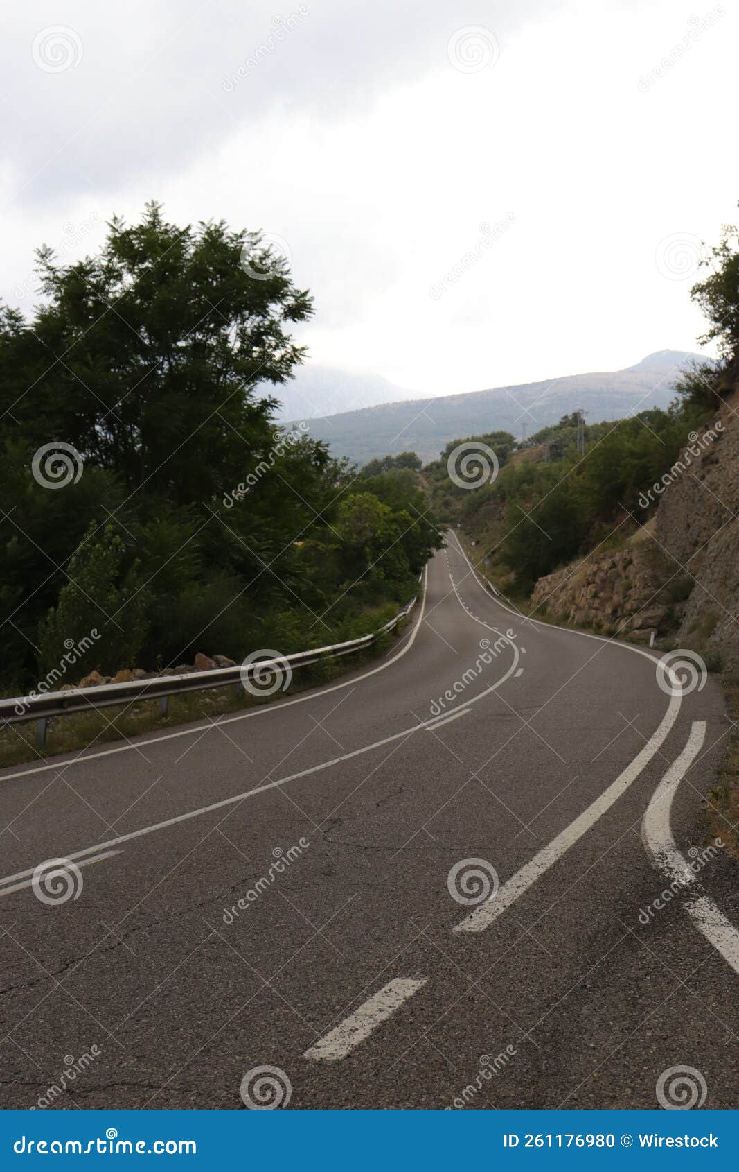 Vertical Low-angle of a Road through Rocky Mountains, Gloomy Sky ...