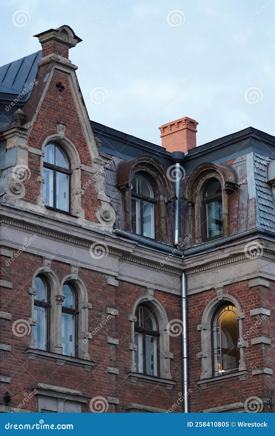Vertical Low-angle of Roofs of a Brick Stone Building, Cloudy Sky in ...