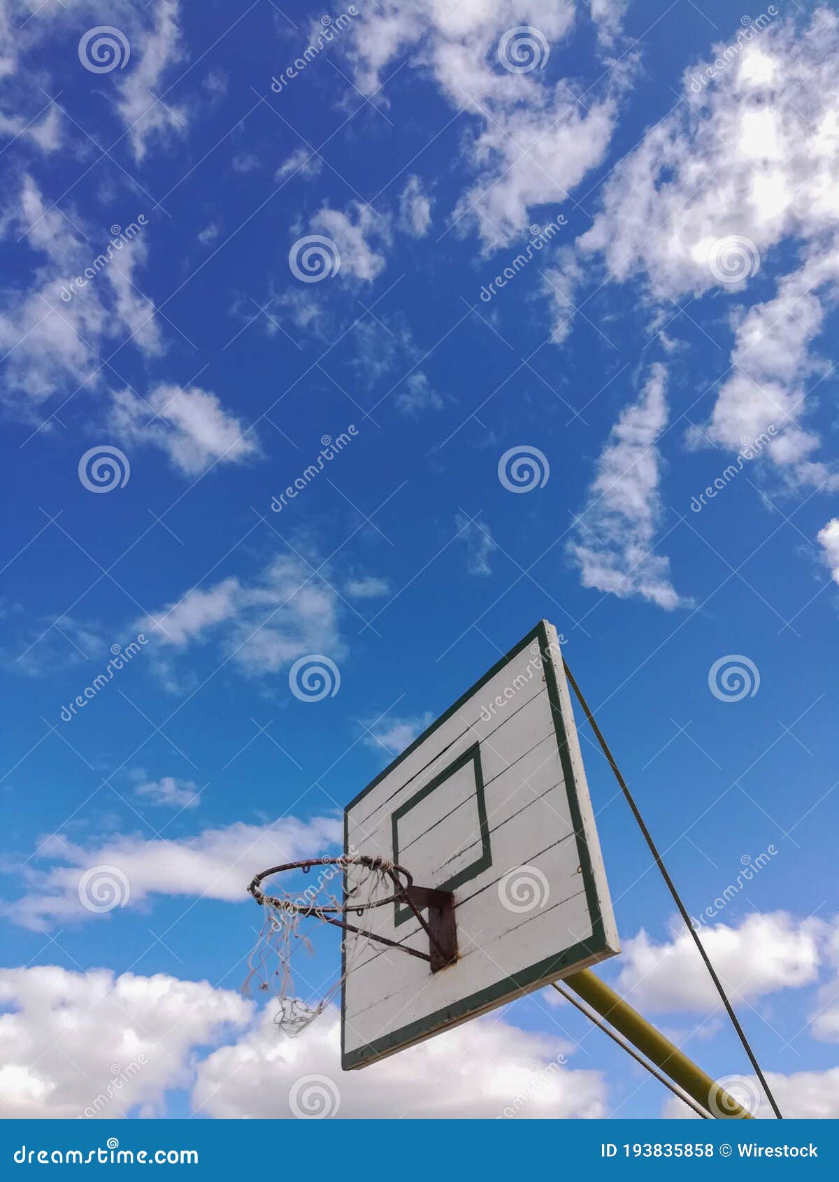 Vertical Low Angle Shot of a Basketball Backboard Under the Cloudy Sky ...
