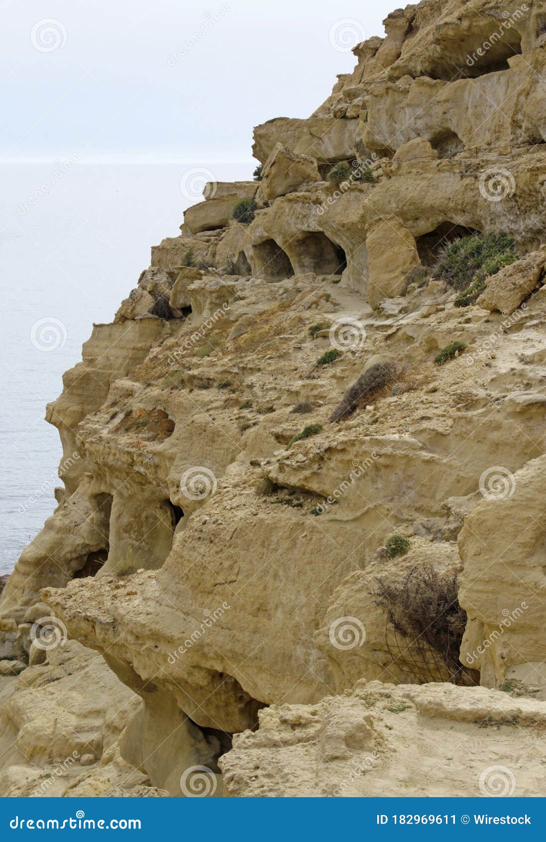 Vertical Low Angle Shot of the Beautiful Rocky Cliffs by the Water ...