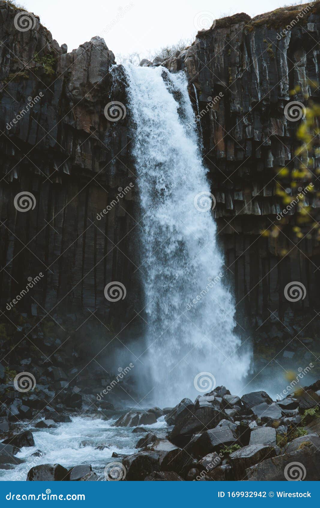 Vertical Low Angle Shot of a Beautiful Waterfall on the Rocky Cliffs ...