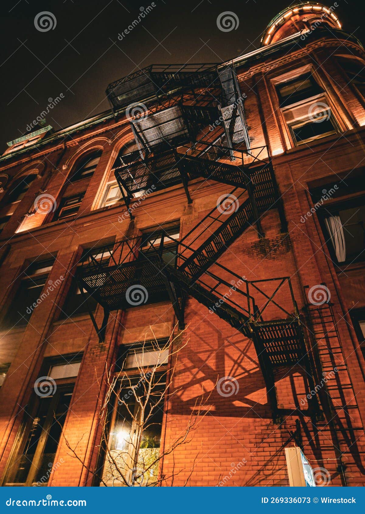 Vertical Low-angle Shot of a Building with a Fire Escape at Night ...