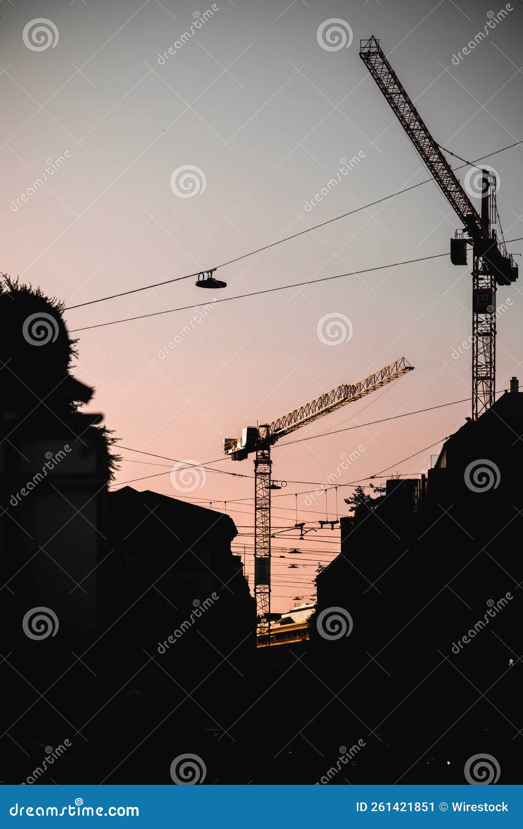 Vertical Low Angle Shot of Canes on a Construction Site during Sunset ...